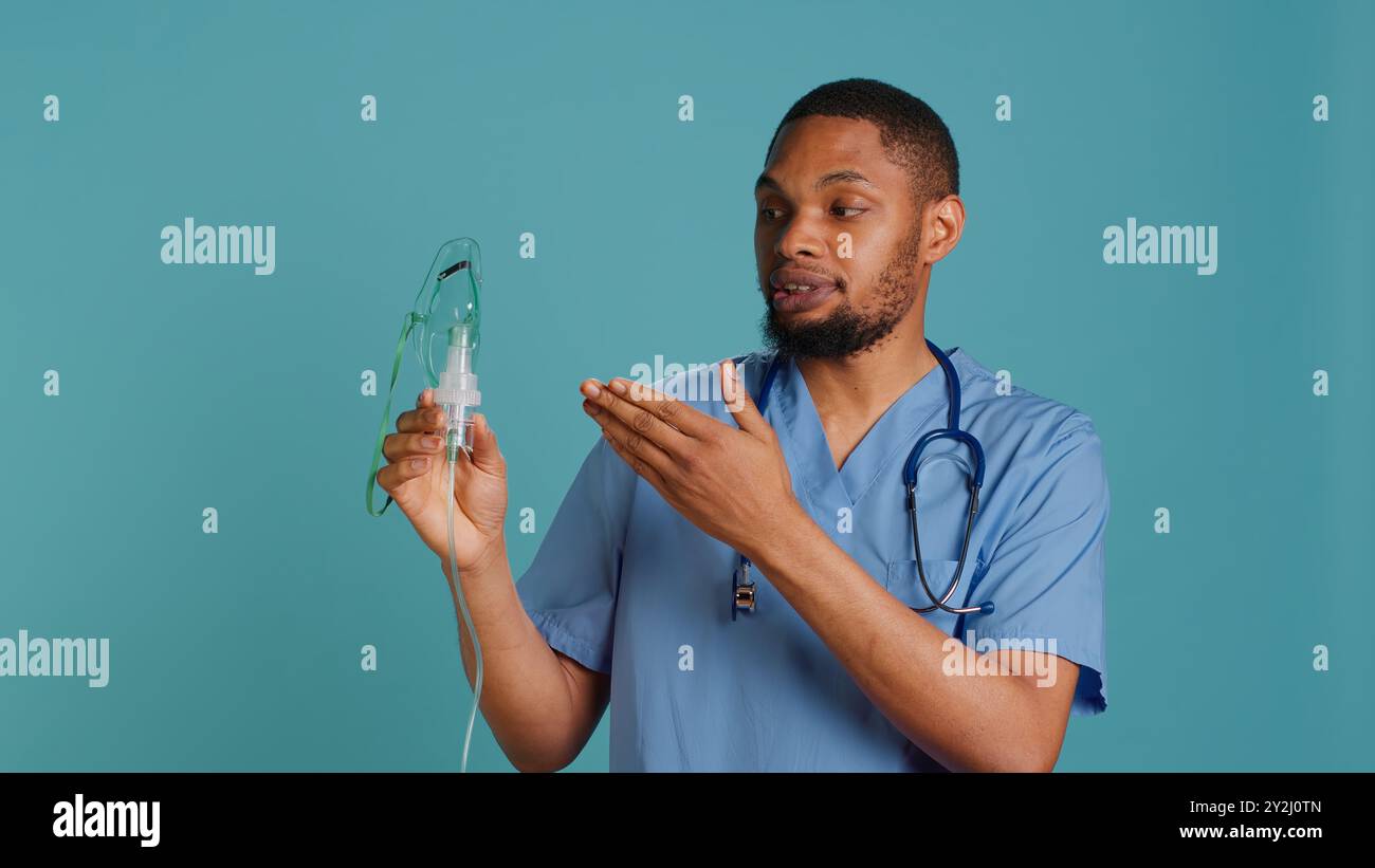 Male nurse doing medical instruction video on how to use handheld ...