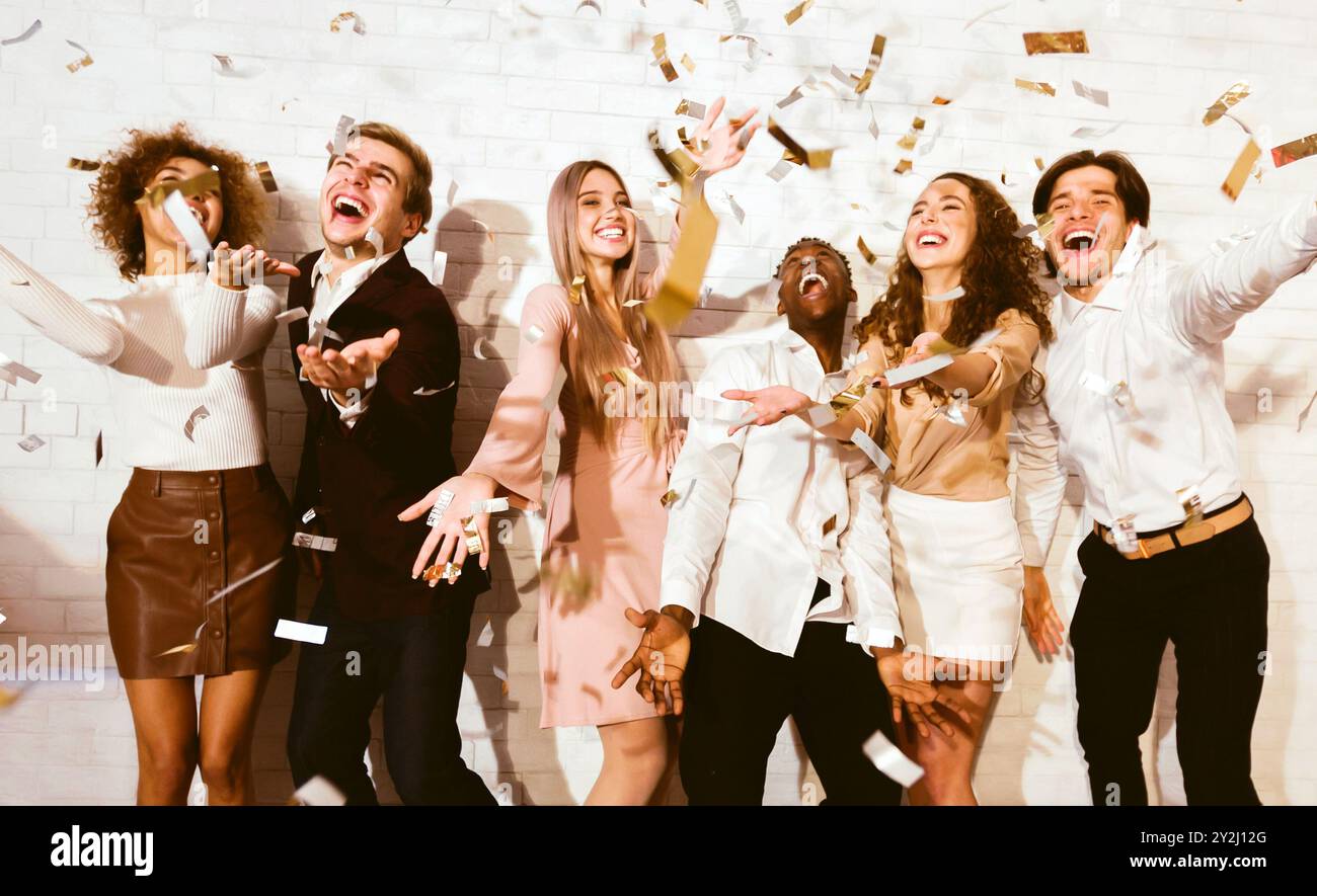 Young People Having Party With Falling Confetti Having Fun Indoors ...