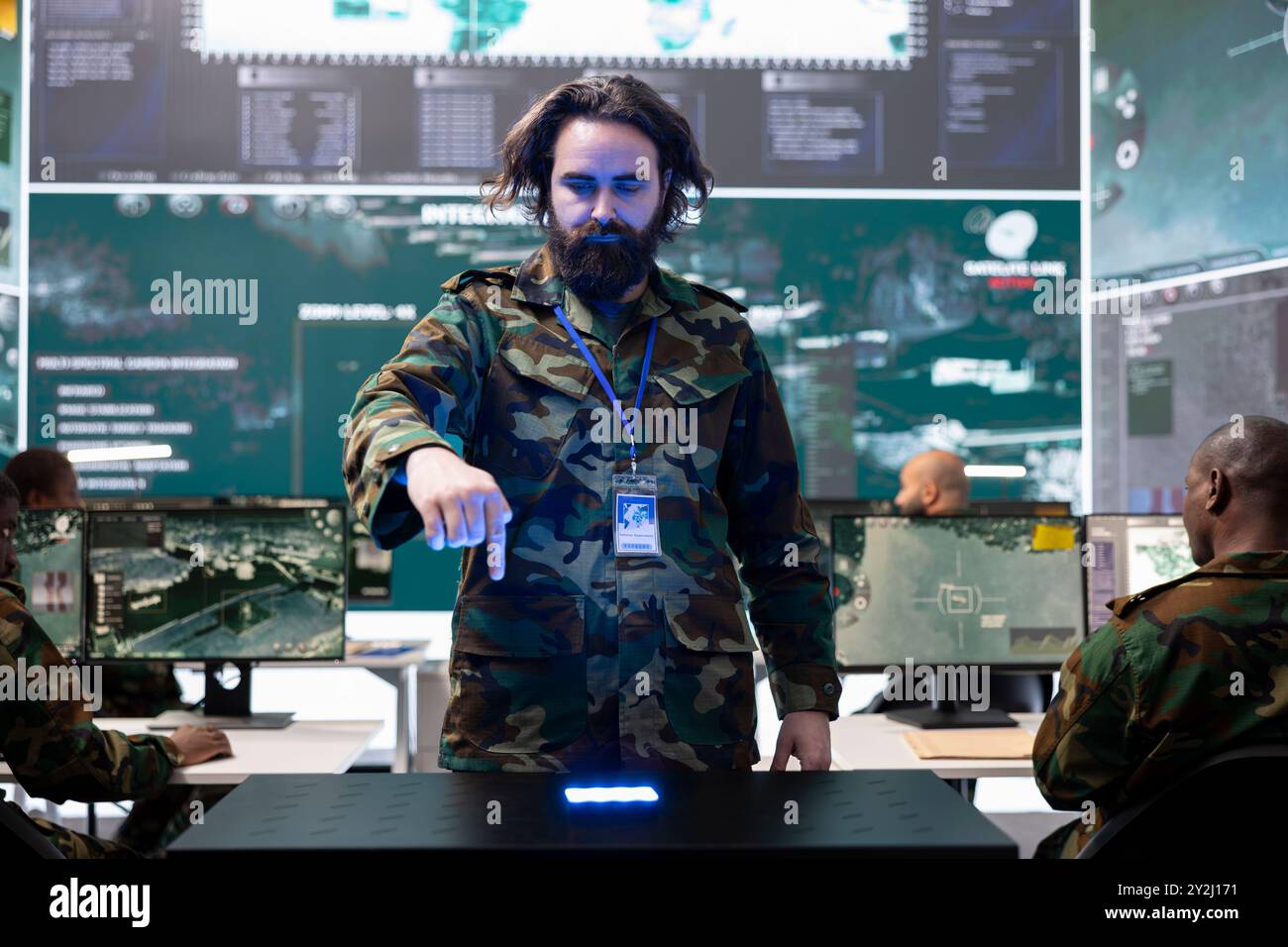 Military personnel examining global satellite CCTV footage on a ...