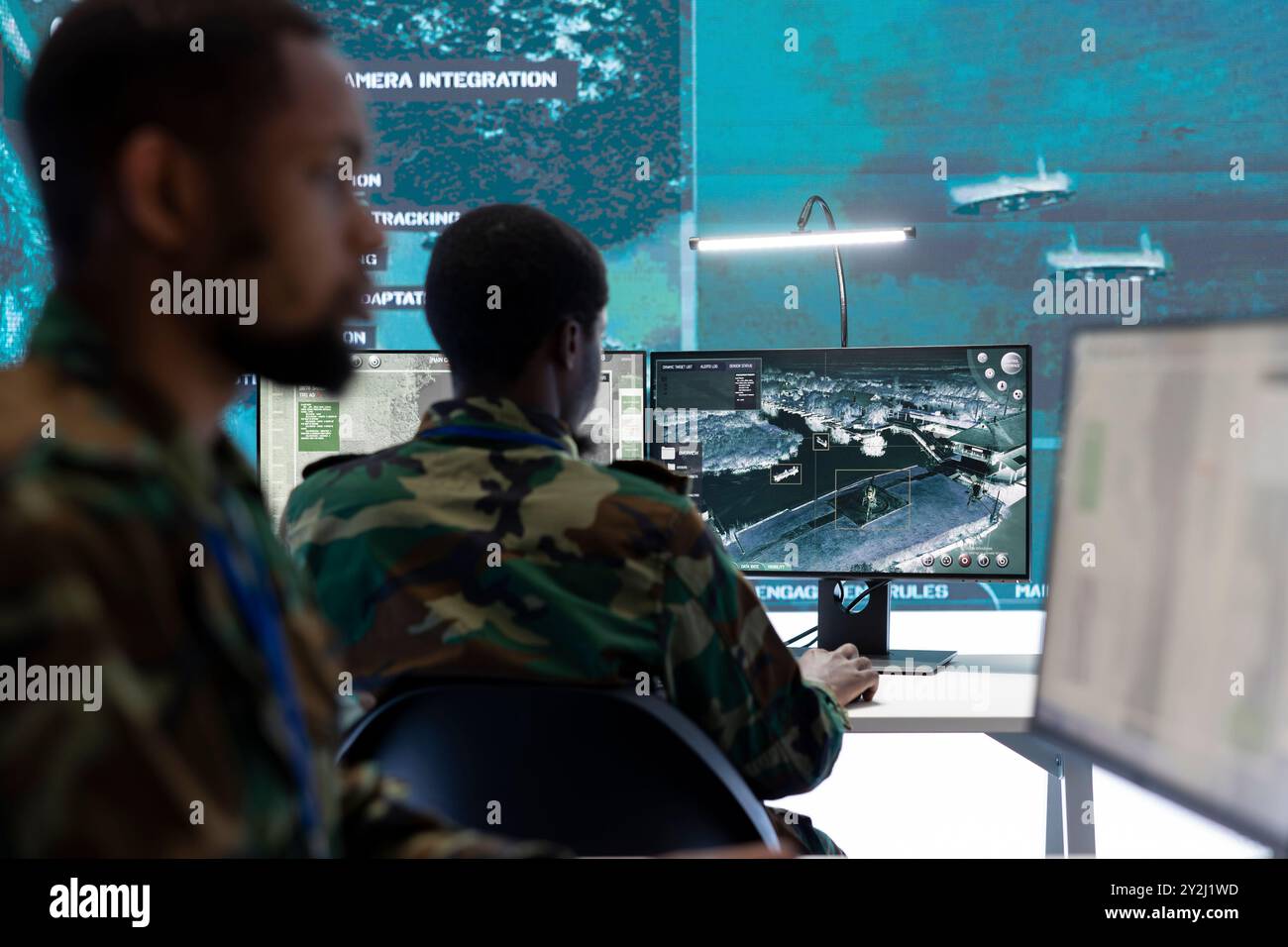 Soldiers in a state of the art military control room collaborate on ...