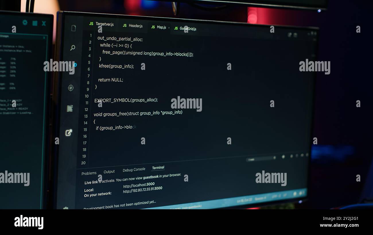 Extreme close up of software interface on PC screens showing lines of code running in empty ...