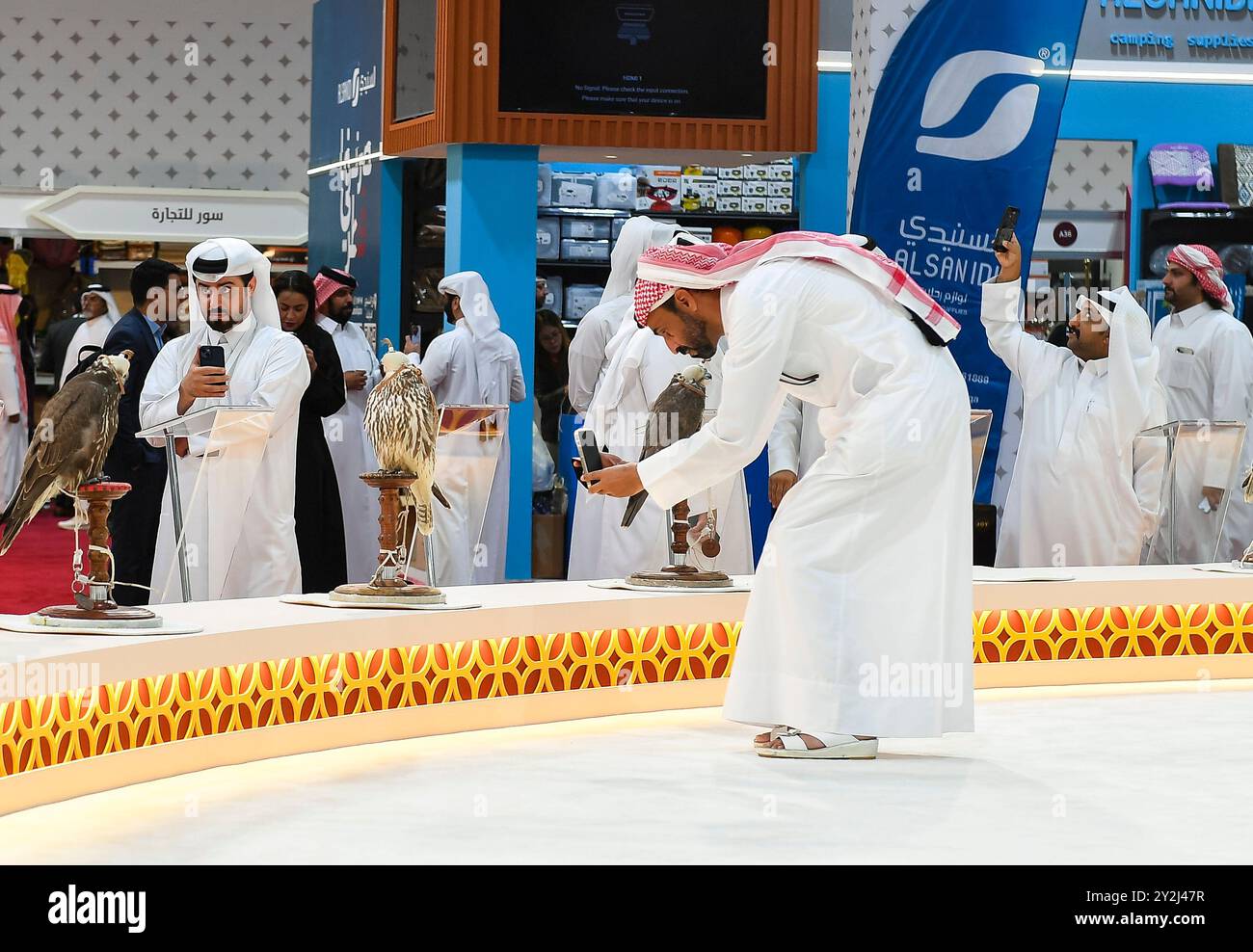 Qatari visitors observe falcons during the 8th edition of the Katara ...