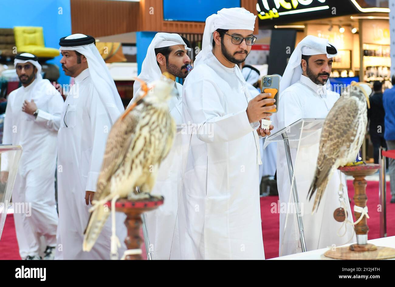 Qatari visitors observe falcons during the 8th edition of the Katara ...