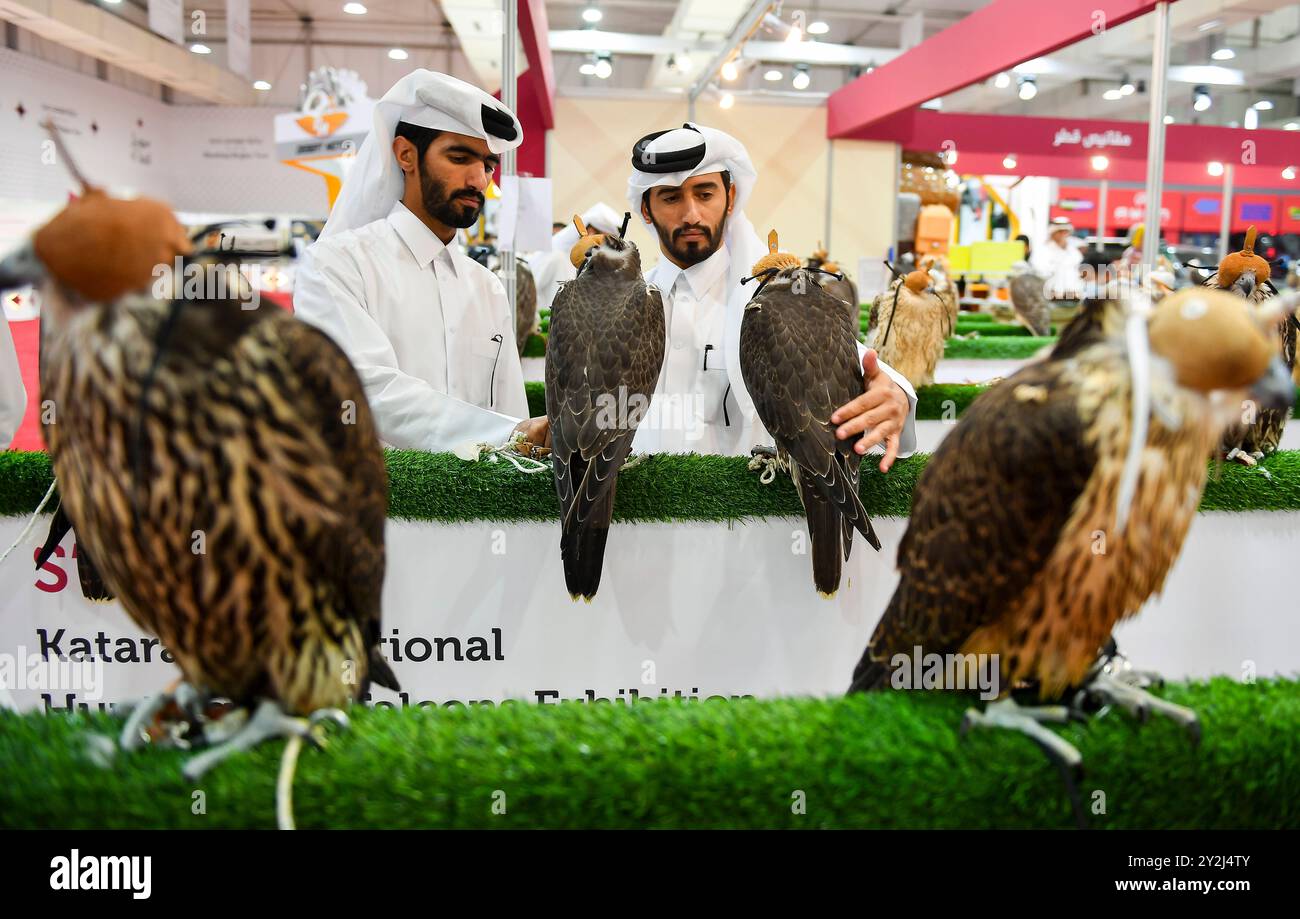 Qatari visitors observe falcons during the 8th edition of the Katara ...