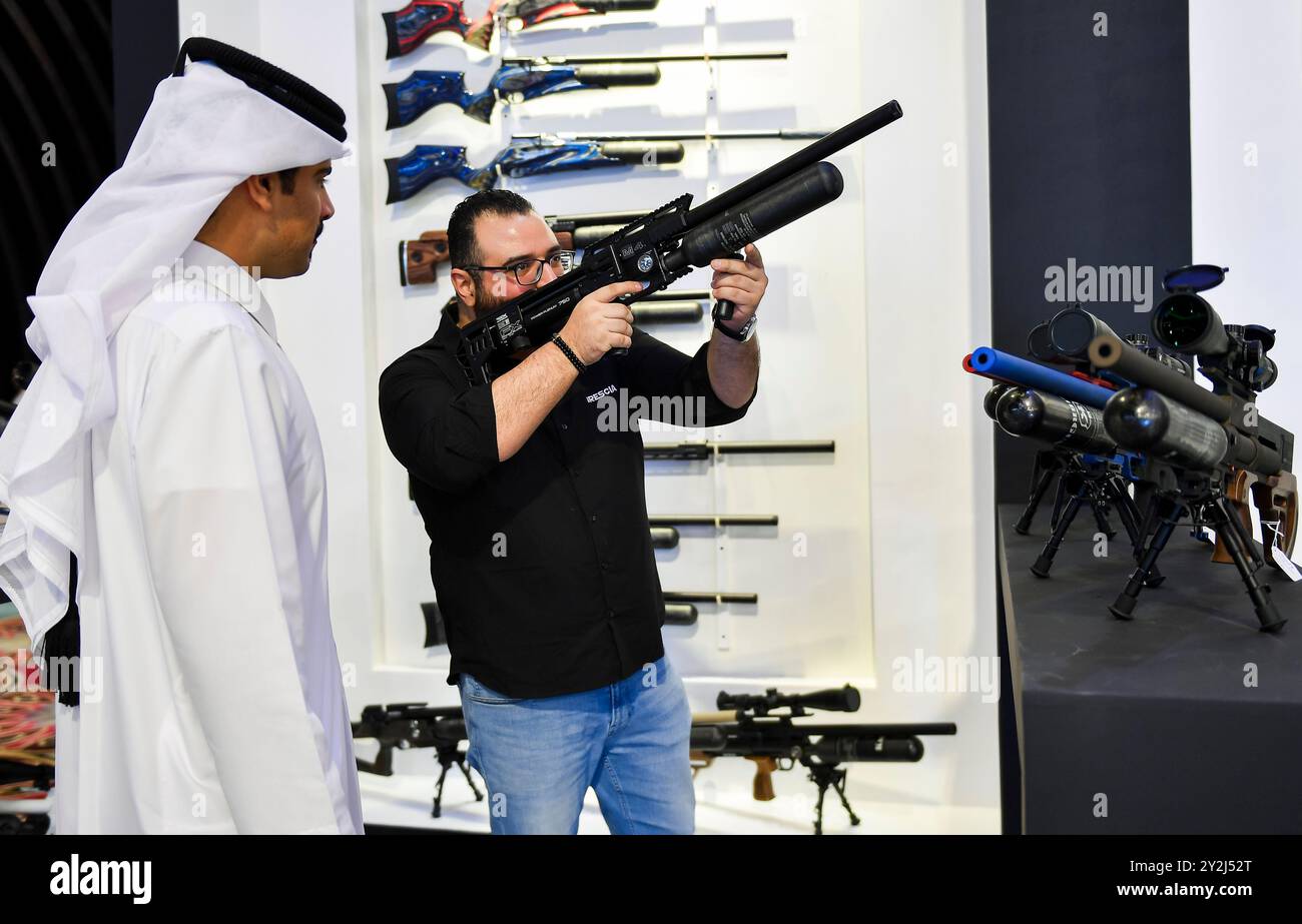 Doha, Qatar. 10th Sep, 2024. People check a hunting rifle in the guns section at the 8th edition ...