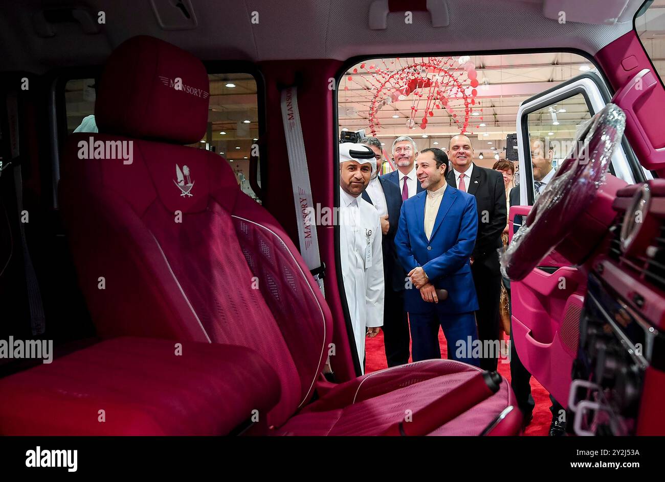 Visitors look at hunting vehicles during the 8th edition of the Katara ...