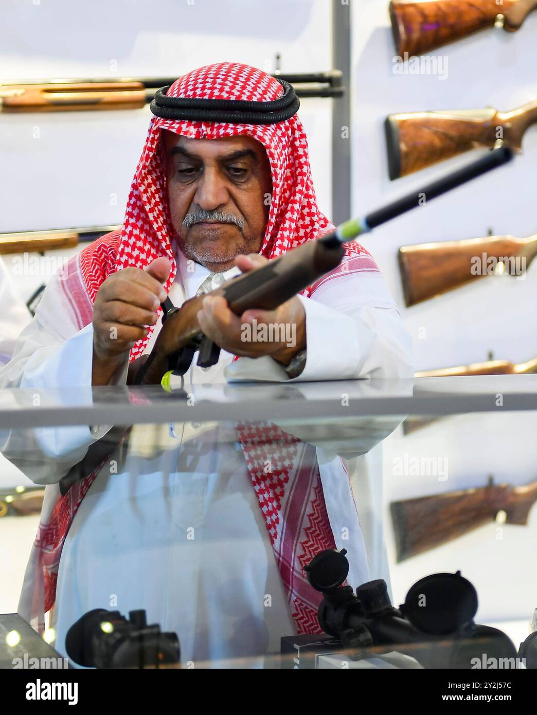 Doha, Qatar. 10th Sep, 2024. People check a hunting rifle in the guns ...