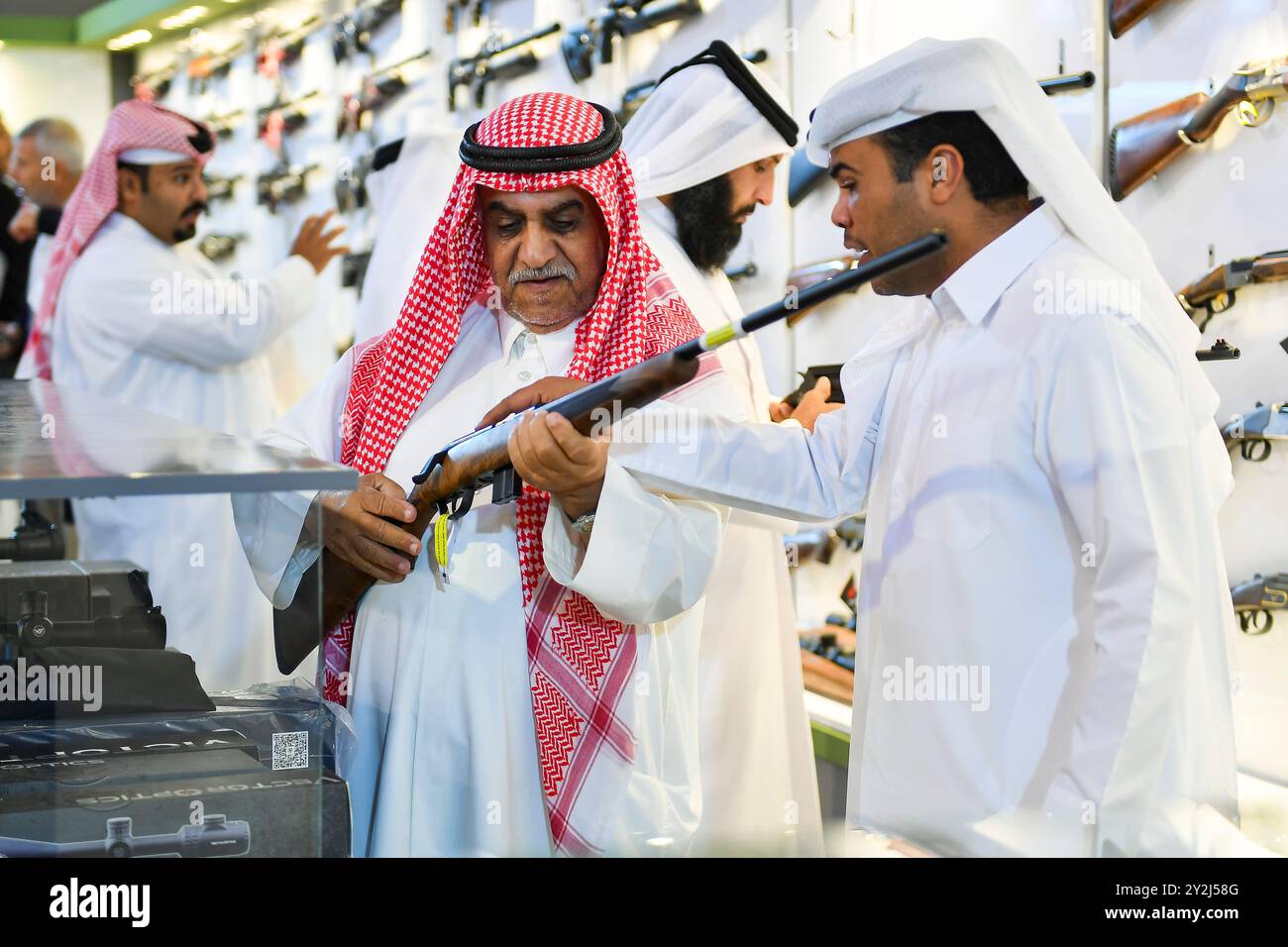 Doha, Qatar. 10th Sep, 2024. People check a hunting rifle in the guns ...