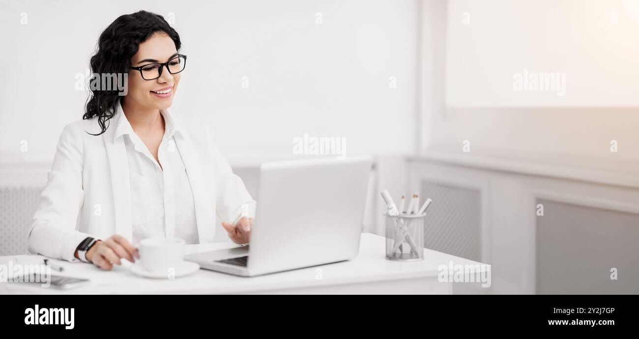 Hispanic manager making video call to family Stock Photo - Alamy