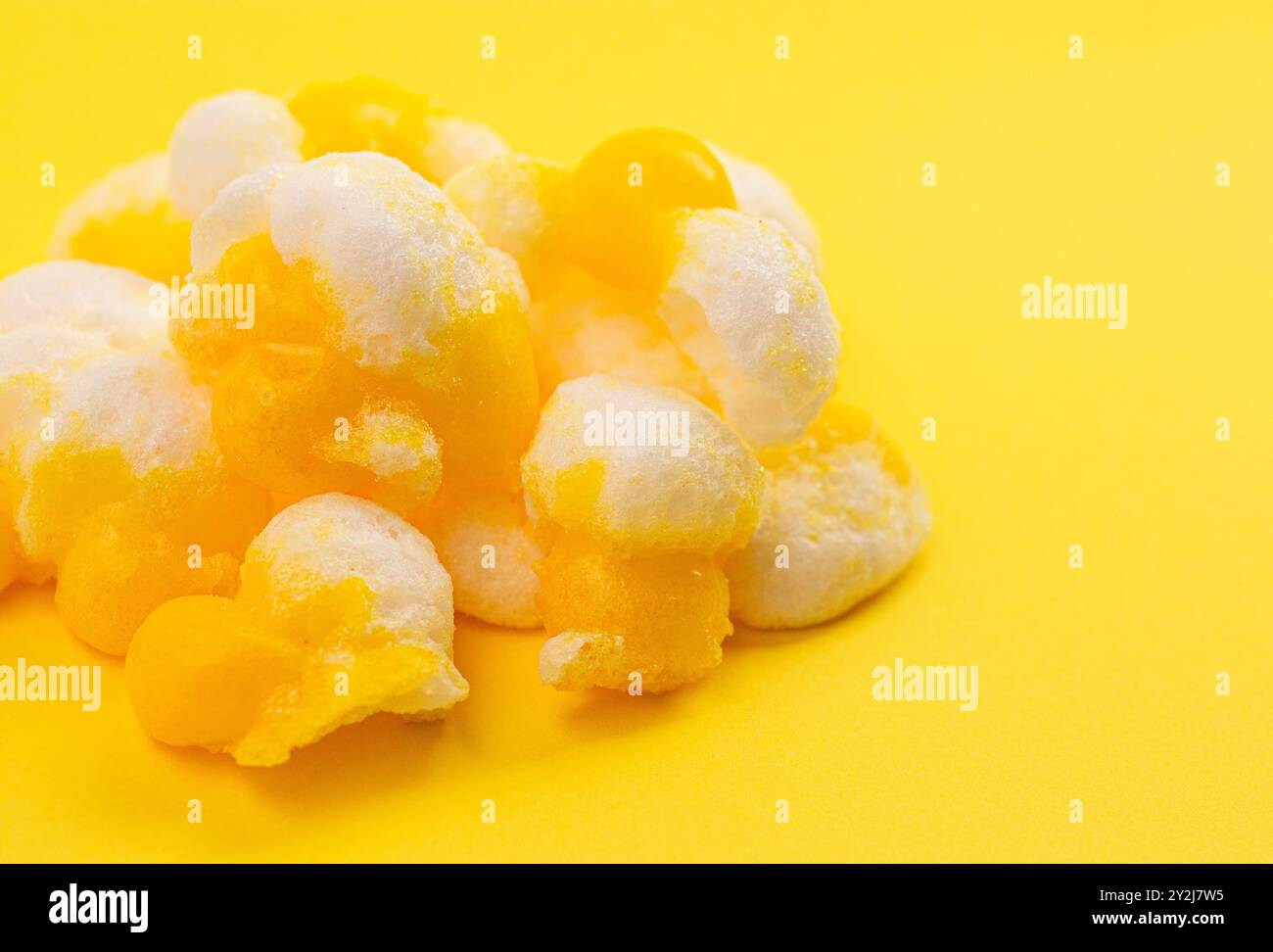 Yellow Freeze Dried Lemon Flavored Candy on a Bright Yellow Background ...