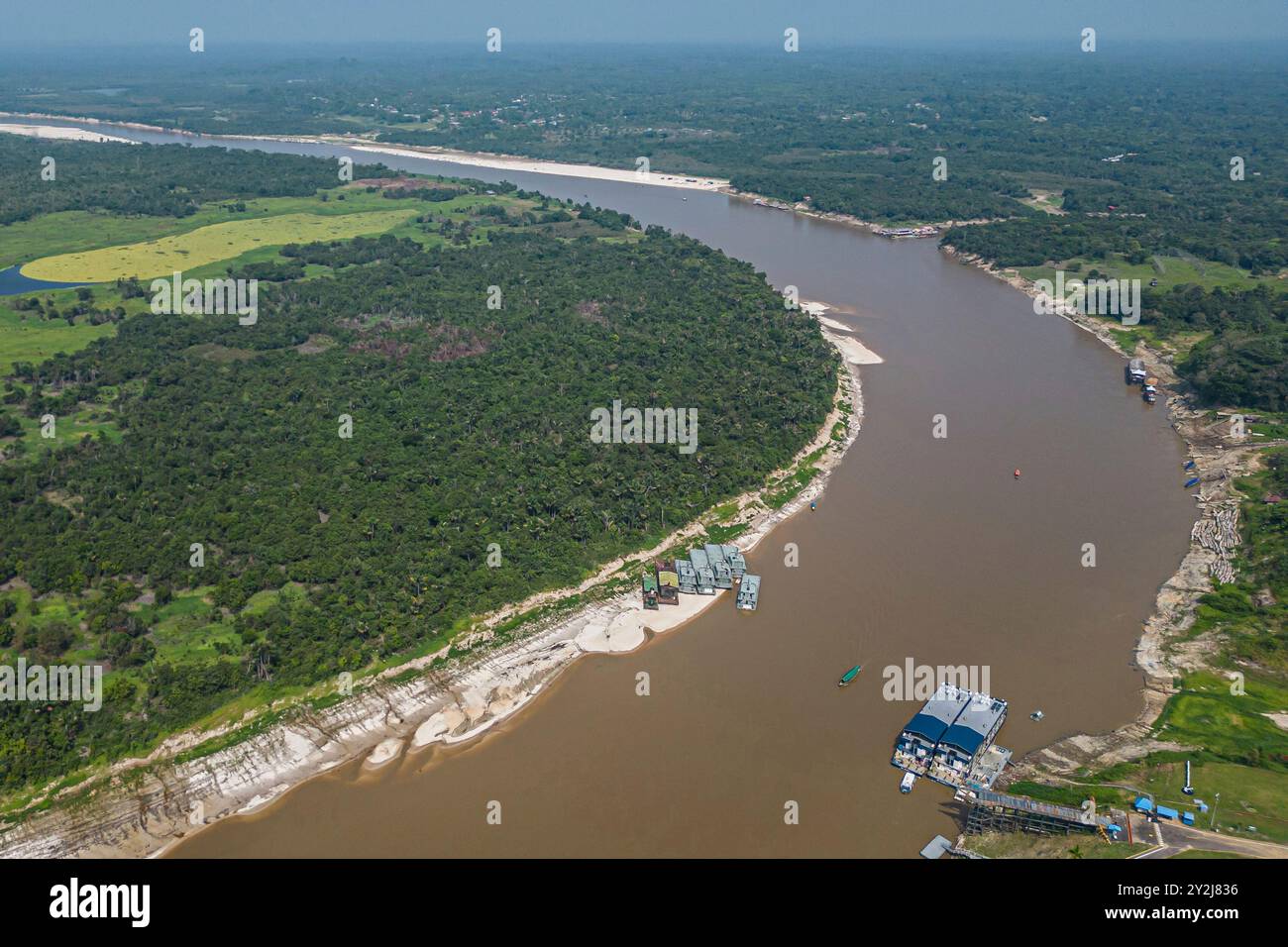 Boats sit on the shore of the Nanay River, a tributary of the Amazon ...
