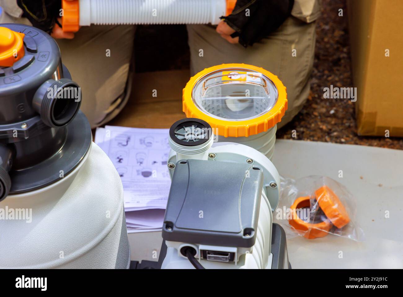 Maintenance worker assembles sand filter system tank cleaning equipment ...