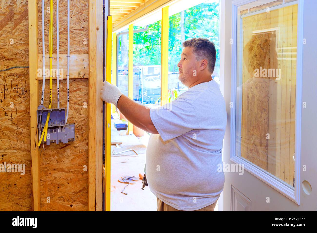 An employee of construction company uses yellow spirit measure level of ...