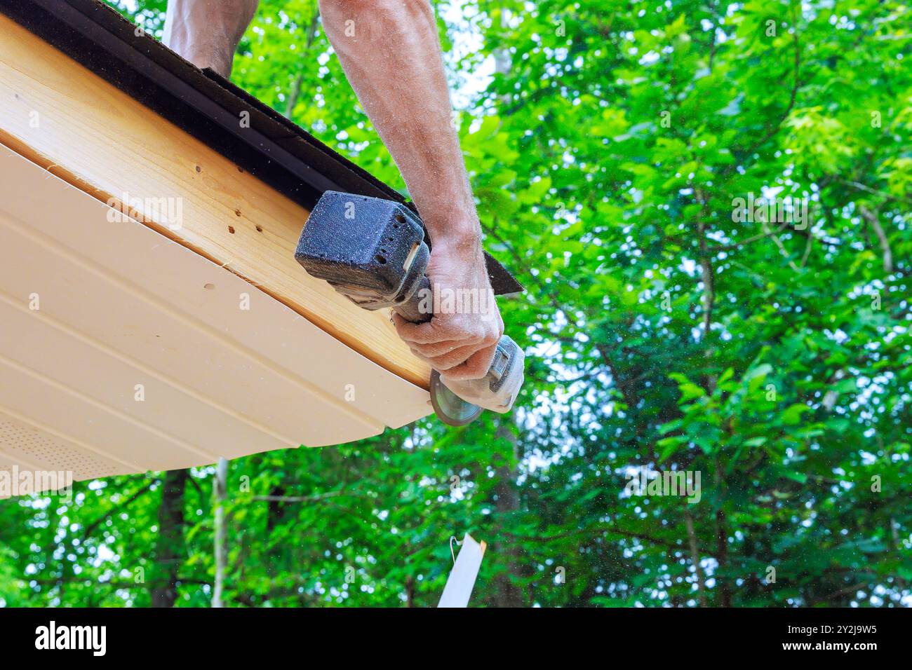 Cutting off established vinyl soffit plastic panels to specified size ...