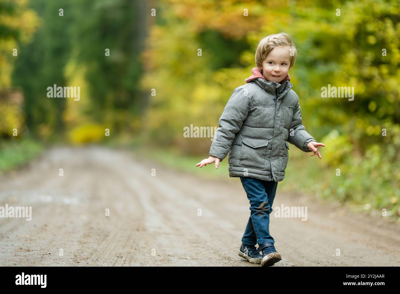 Cute little boy playing outdoors on sunny autumn day. Child exploring ...