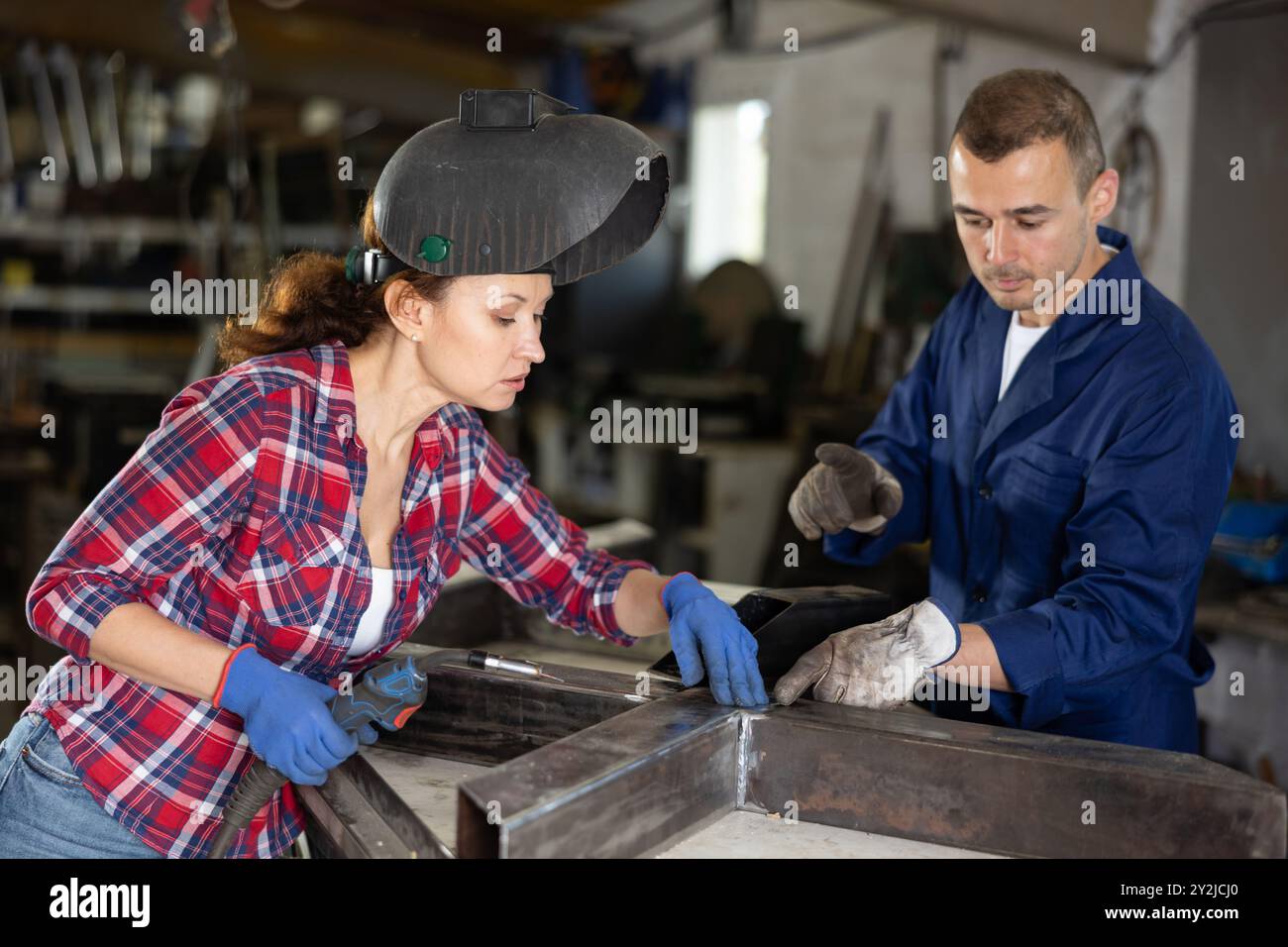 Foreman points out the poor-quality weld that the woman made. Working ...