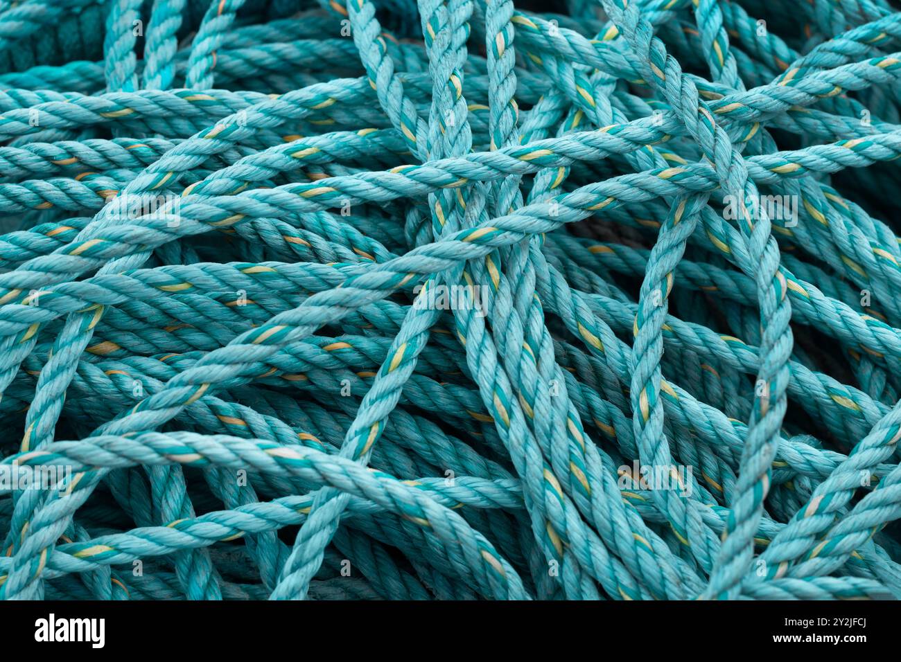Ropes - A heap of ropes tangled on fishing harbour dock. High angle ...