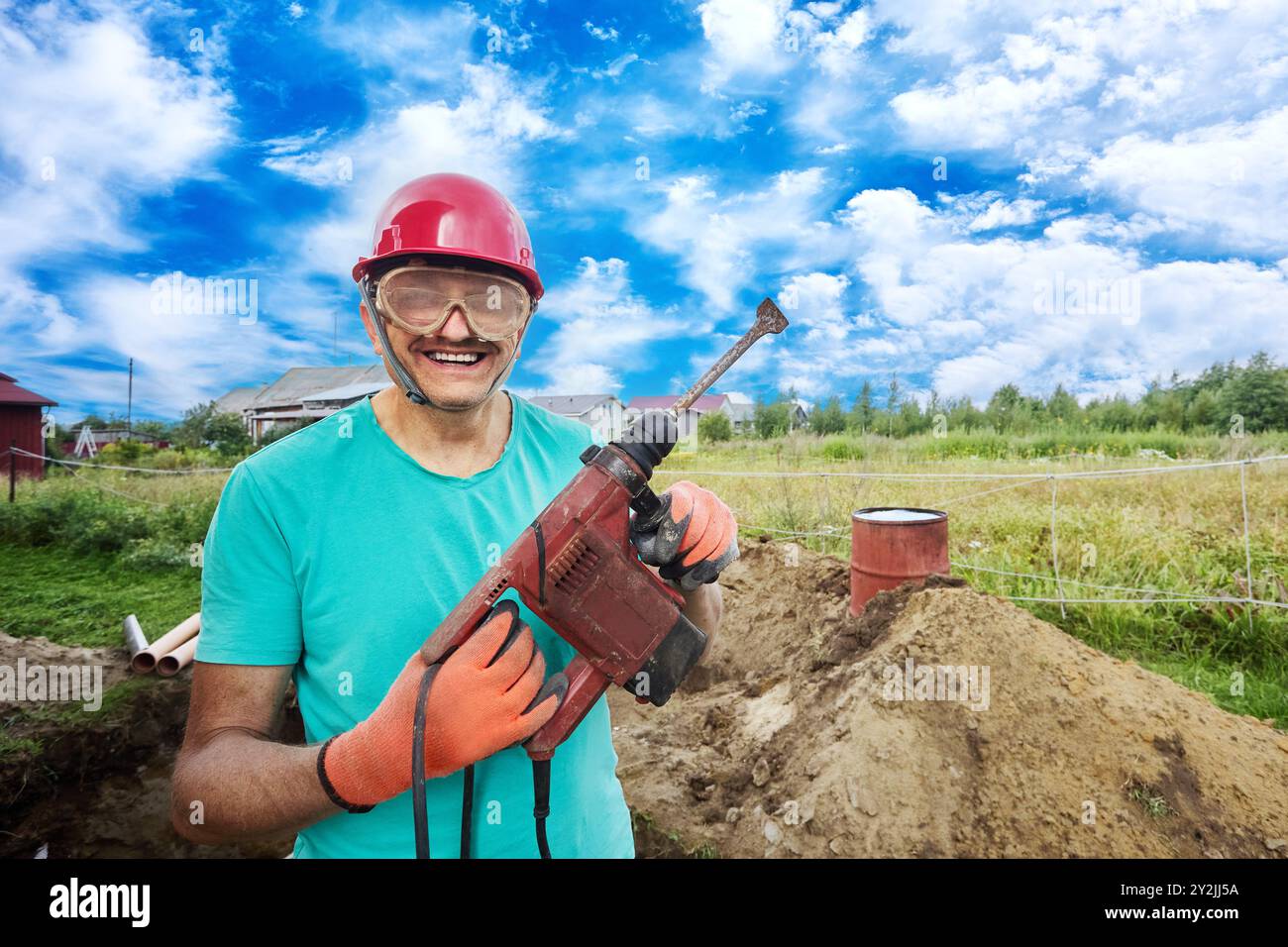 Mature smiling middle aged man in construction helmet and safety ...