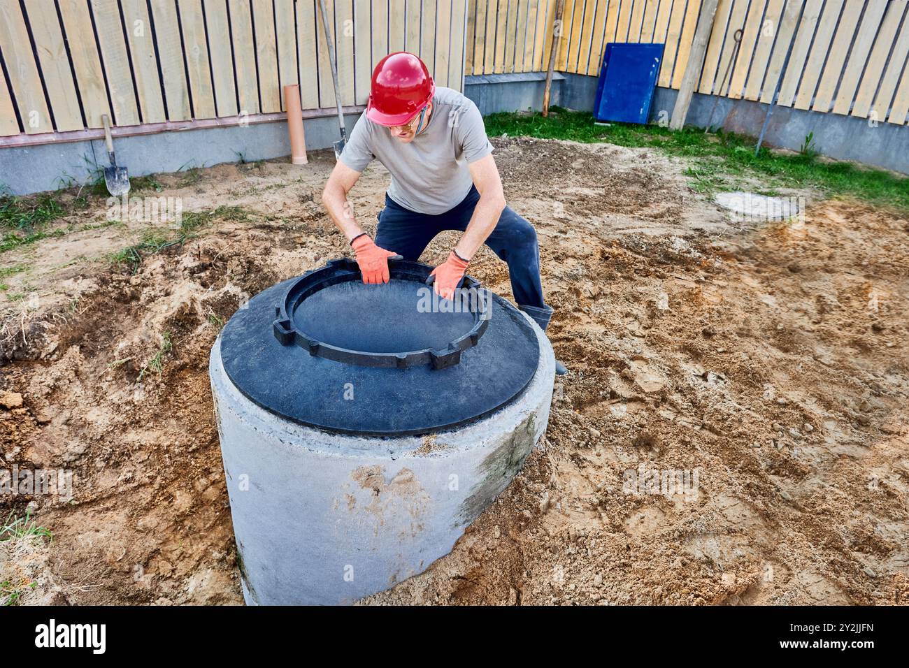 Installing fiberglass support ring under manhole cover for concrete ...