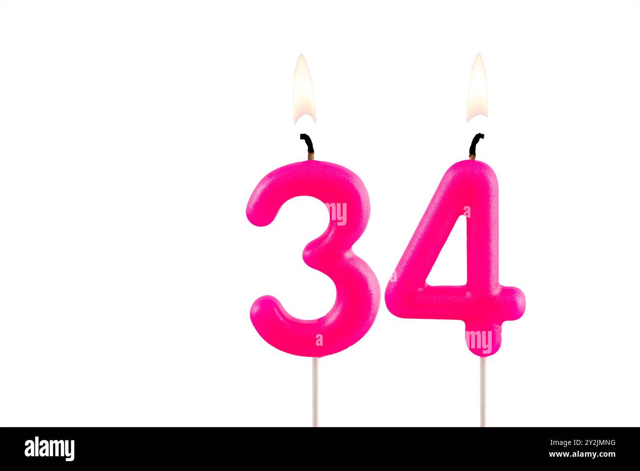 Pink number 34 birthday candle lit on white background Stock Photo - Alamy