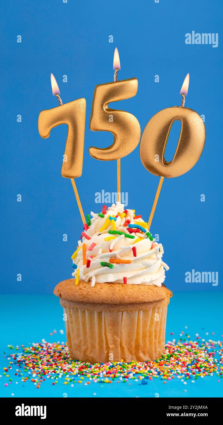 Candle number 750 - Cupcake birthday in blue background Stock Photo - Alamy