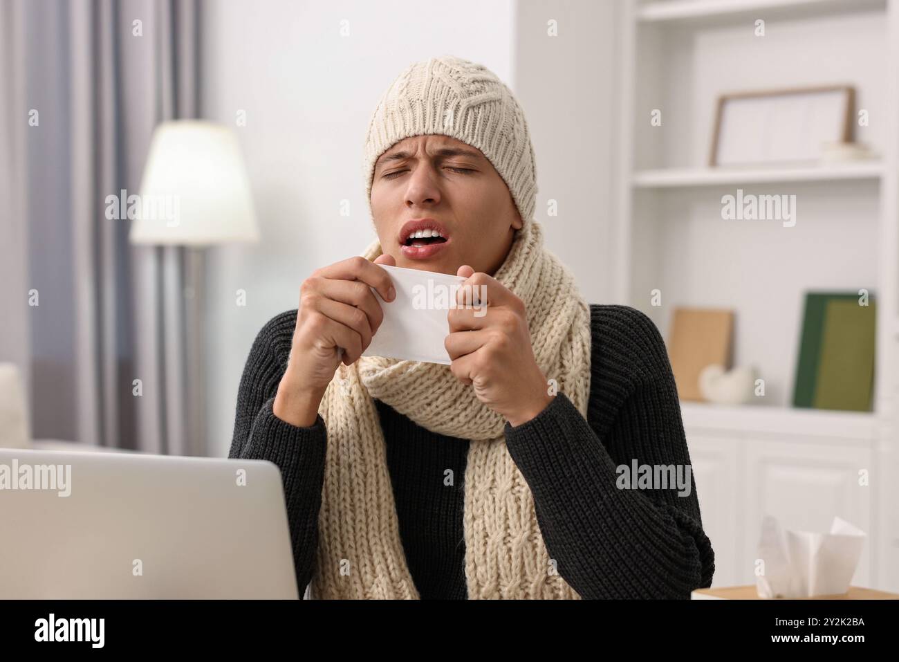 Cold symptom. Young man coughing at home Stock Photo - Alamy
