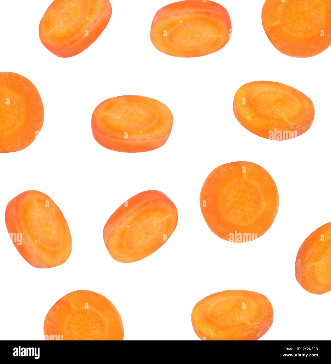 Round carrot slices in air on white background Stock Photo - Alamy