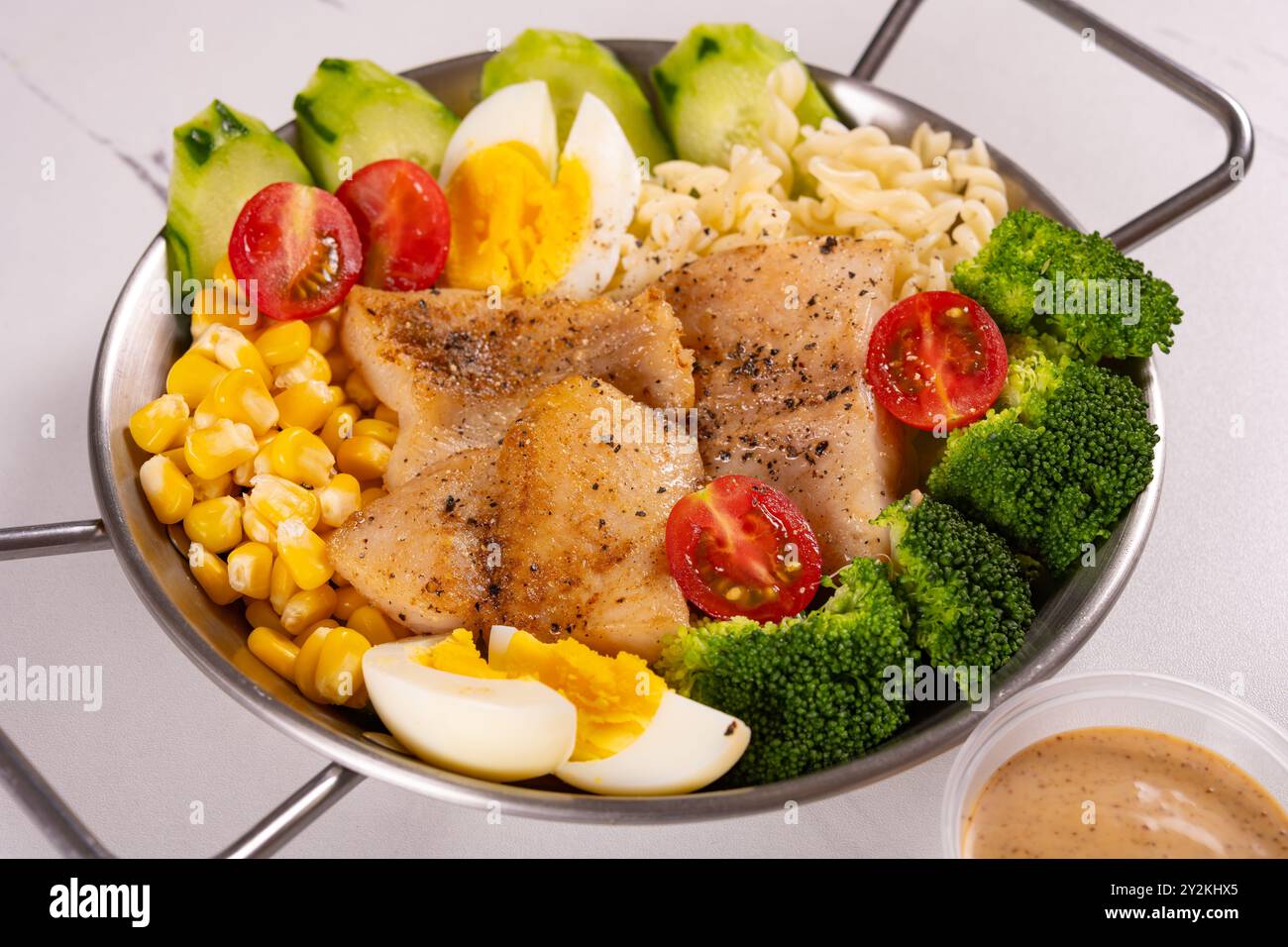 angle view dish of sole fish with eggs and fusilli and cauliflower ...