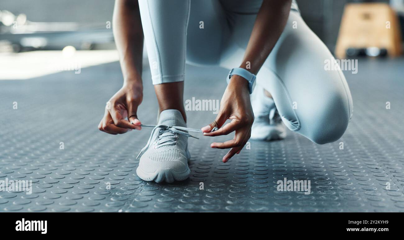 Gym, hands and woman with shoelace for fitness, exercise and workout with safety. Female person ...