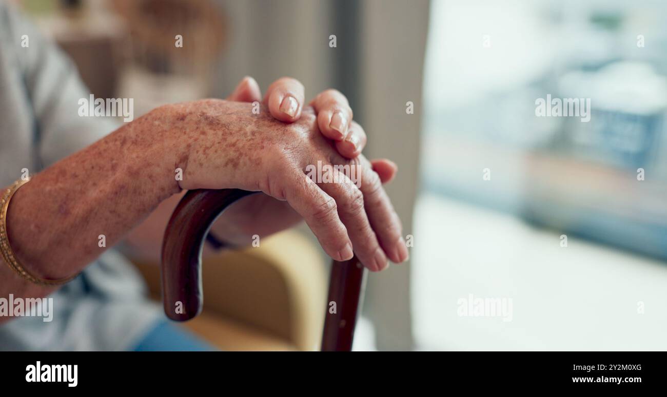 Hands, walking stick and couch in home for senior person with disability, mobility and recovery ...