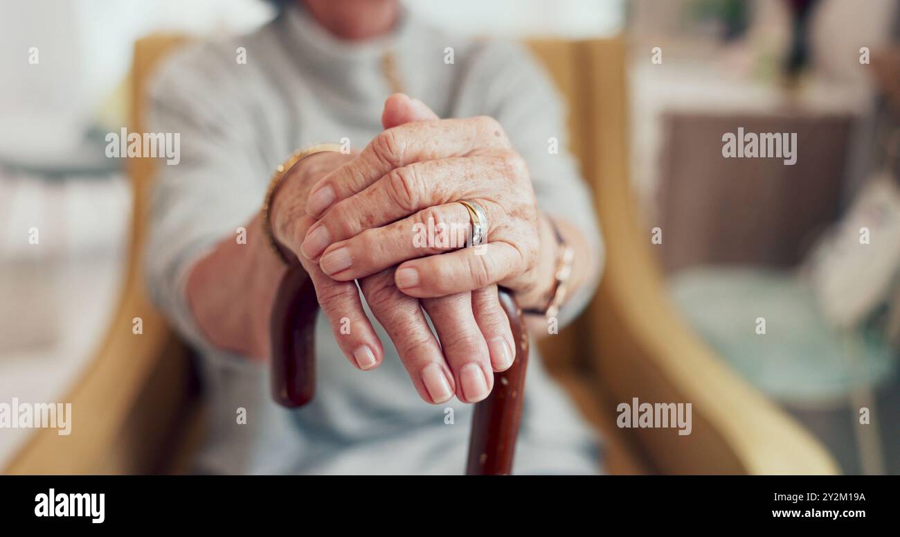 Hands, cane and sofa in home for senior person with disability ...