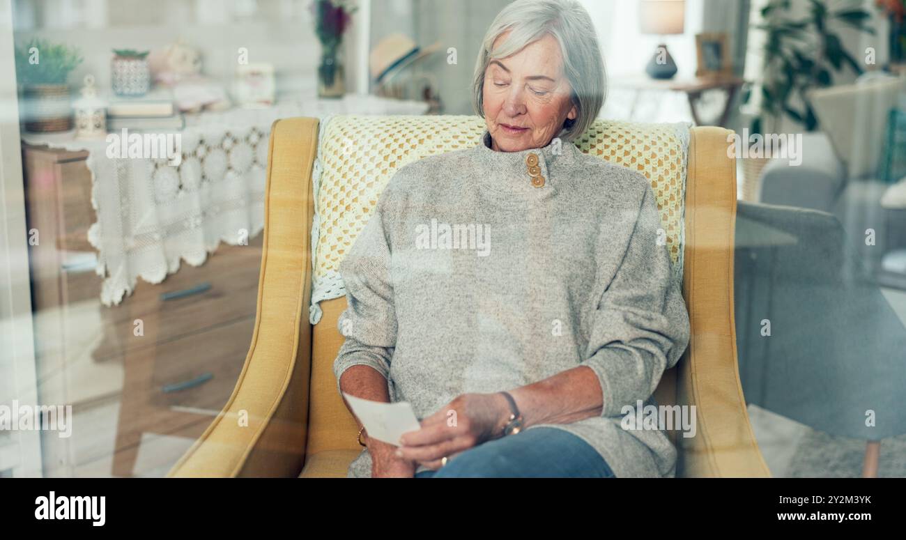 Senior woman, picture and memory in retirement home with nostalgia, peace and calm. Elderly lady ...