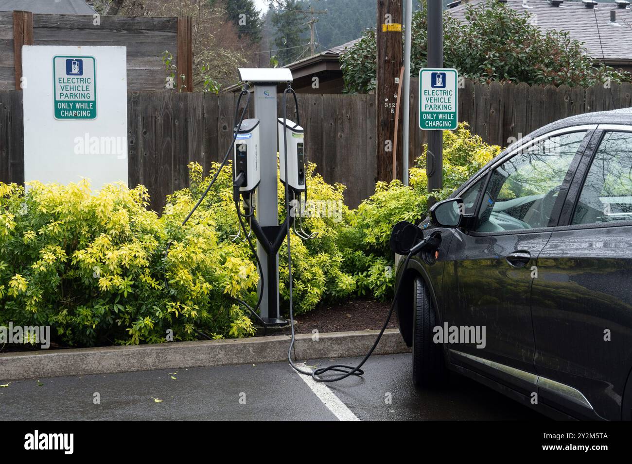 Electric vehicle charging at station, Eugene, Oregon, USA Stock Photo ...