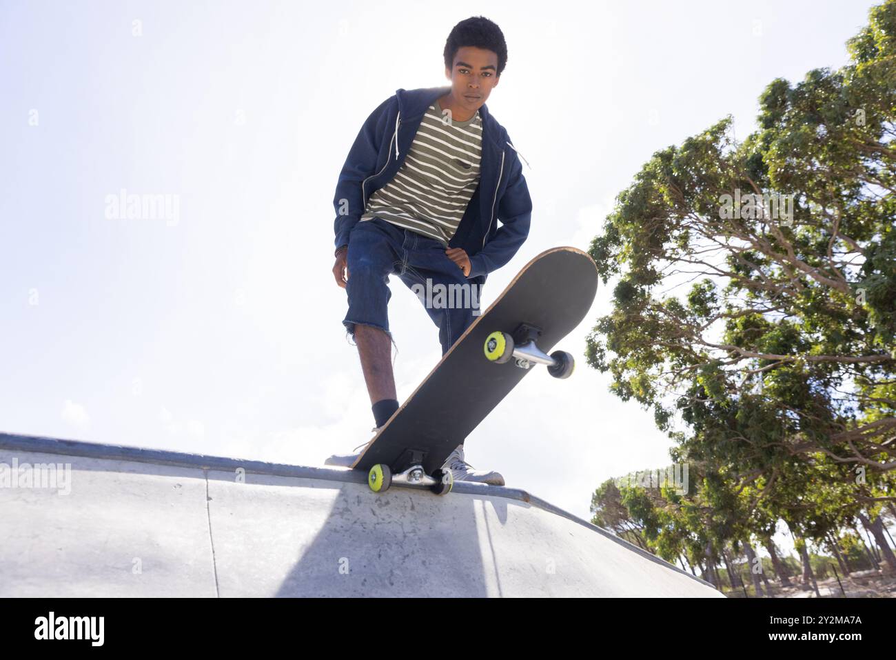 Outdoors, skateboarding, teenage african american teenage boy preparing ...