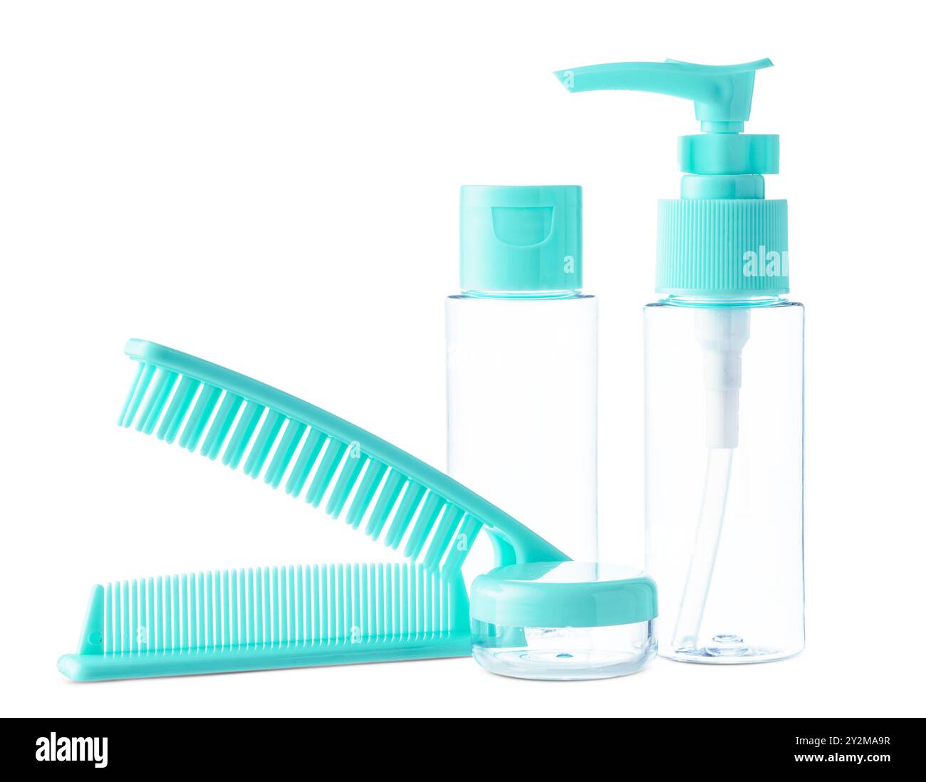 Clear cosmetic containers with turquoise lids and a comb arranged ...