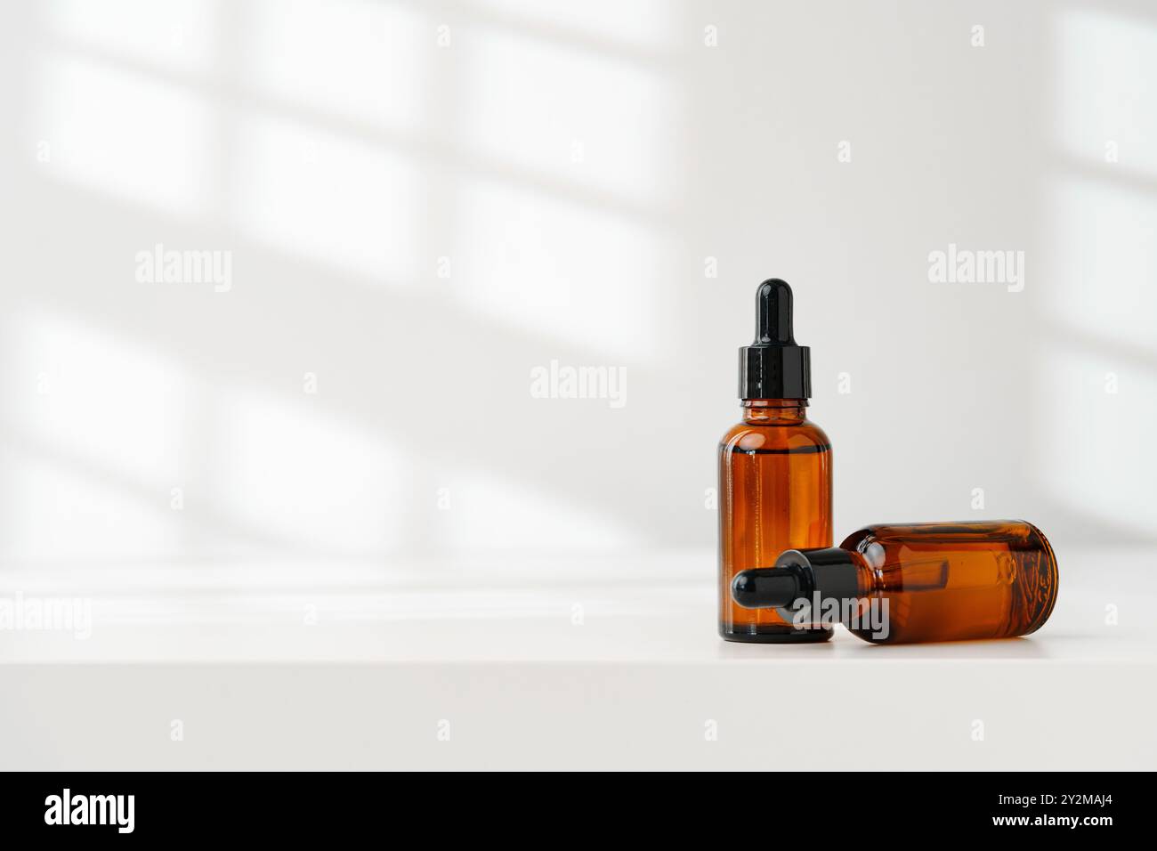 Collection of Amber Glass Dropper Bottles Displayed on a Minimalist ...