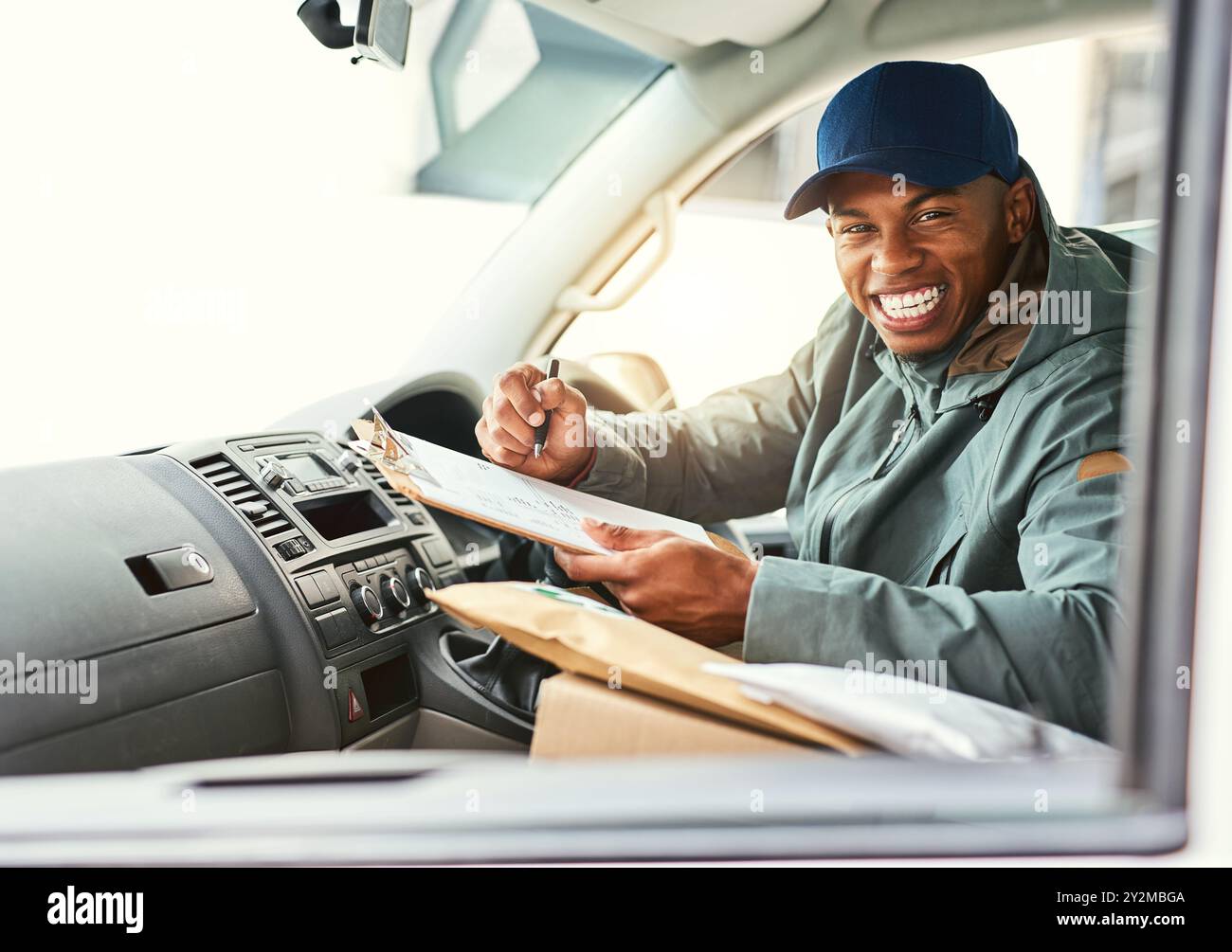 Portrait, courier service and delivery man in vehicle with clipboard ...