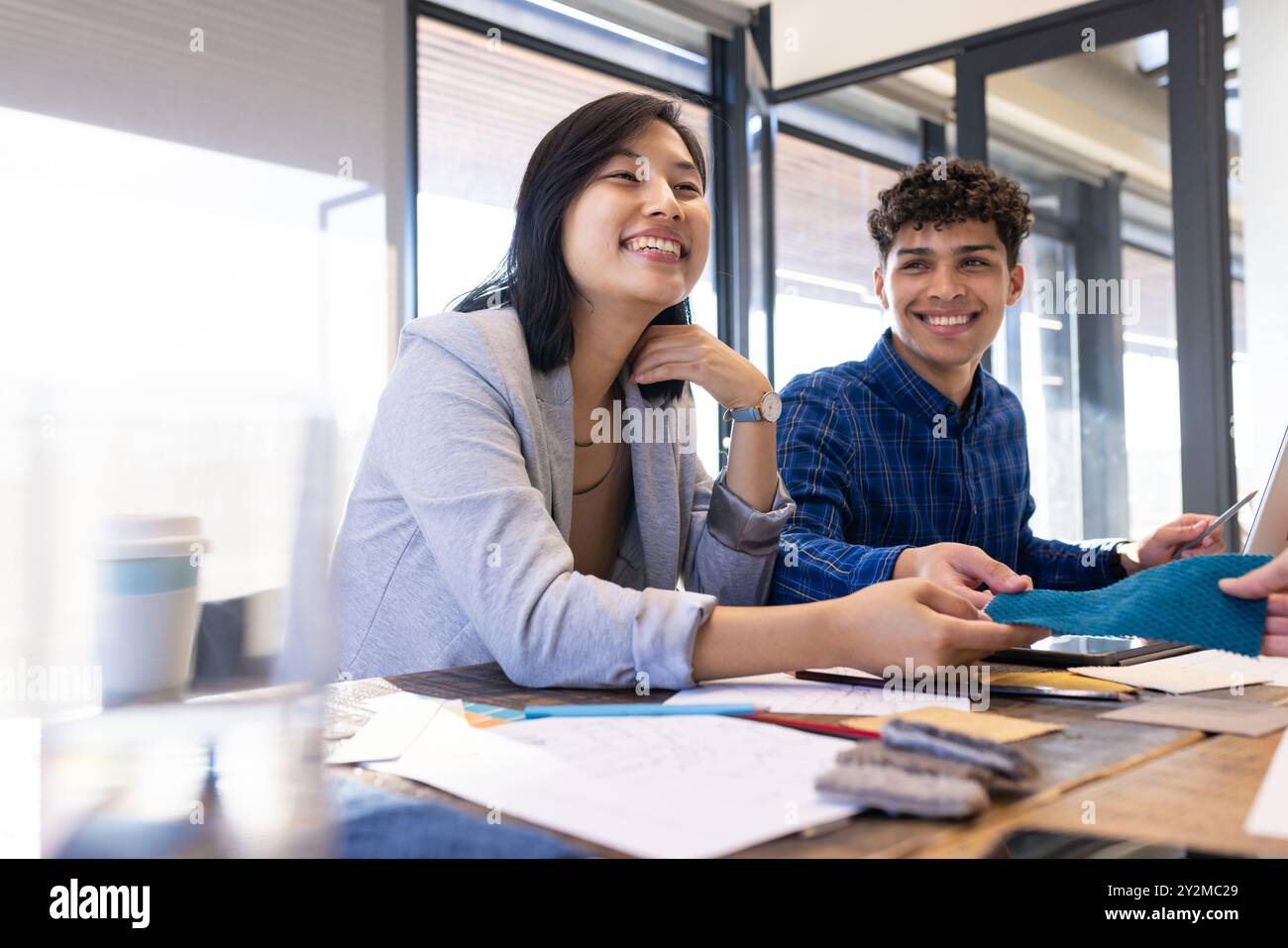 Diverse colleagues sharing fabric samples and ideas in office. teamwork, collaboration ...