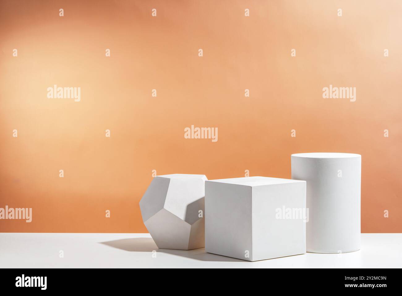 White geometric shapes arranged stylishly on a soft peach background in ...