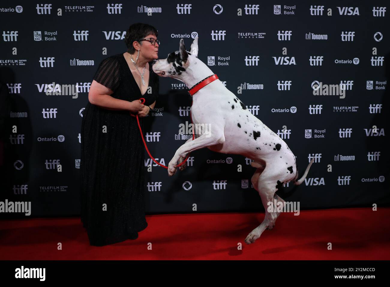 Bev Klingensmith poses for a photo with Bing the Dog as they attend the ...