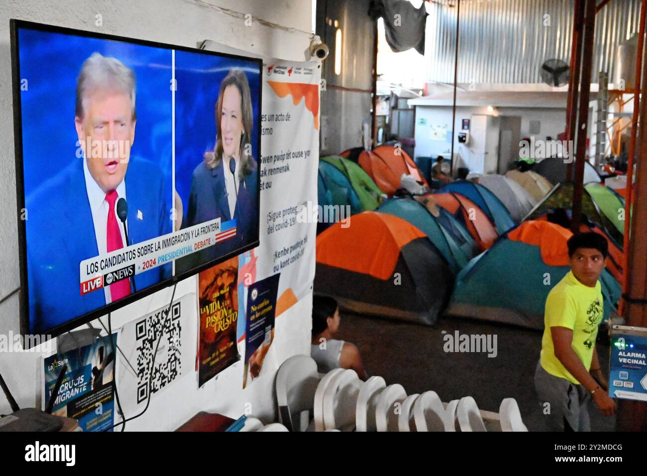 Tijuana, Baja California, Mexico. 10th Sep, 2024. Migrants watch the ...