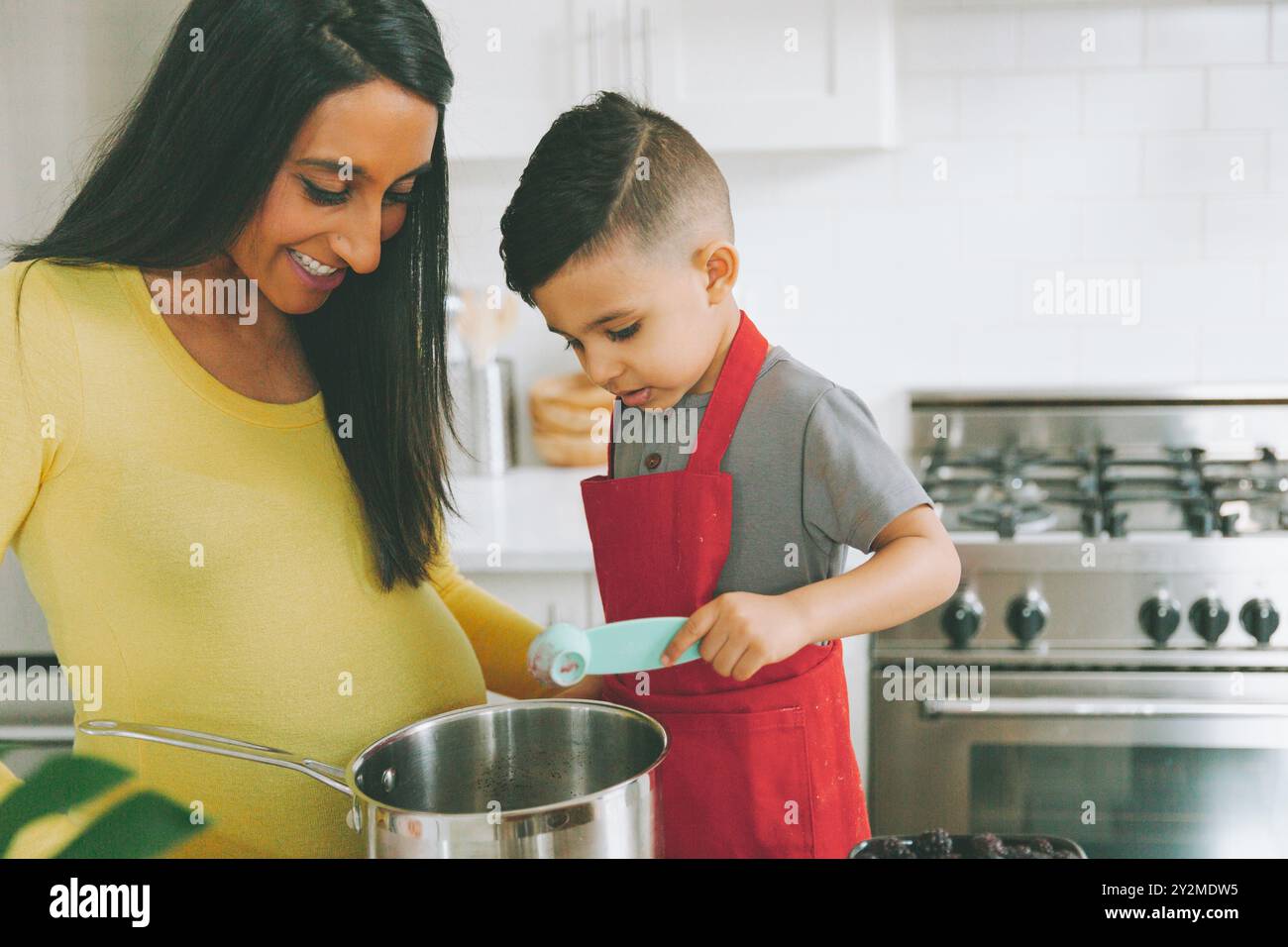 Mom cooking for boy hi-res stock photography and images - Alamy