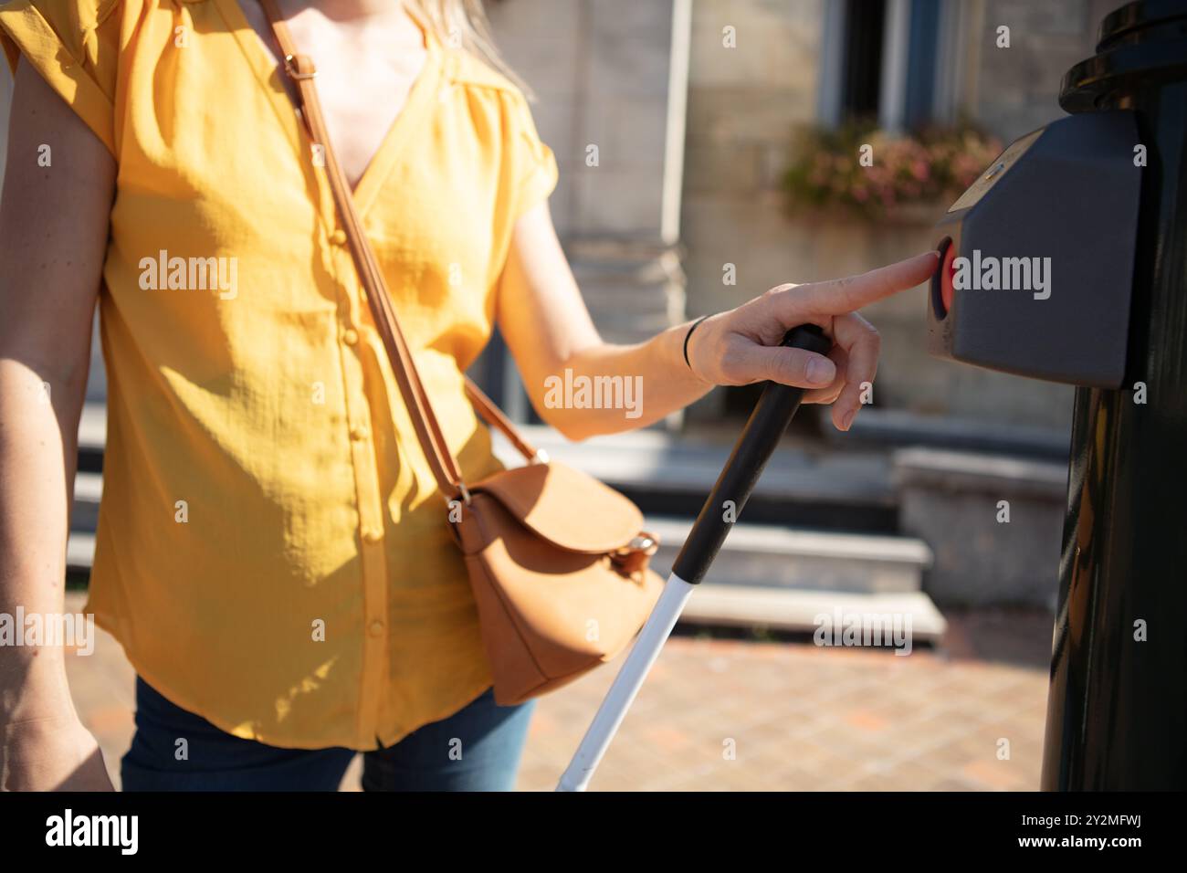 young blind woman pushing button to cross the street Stock Photo - Alamy
