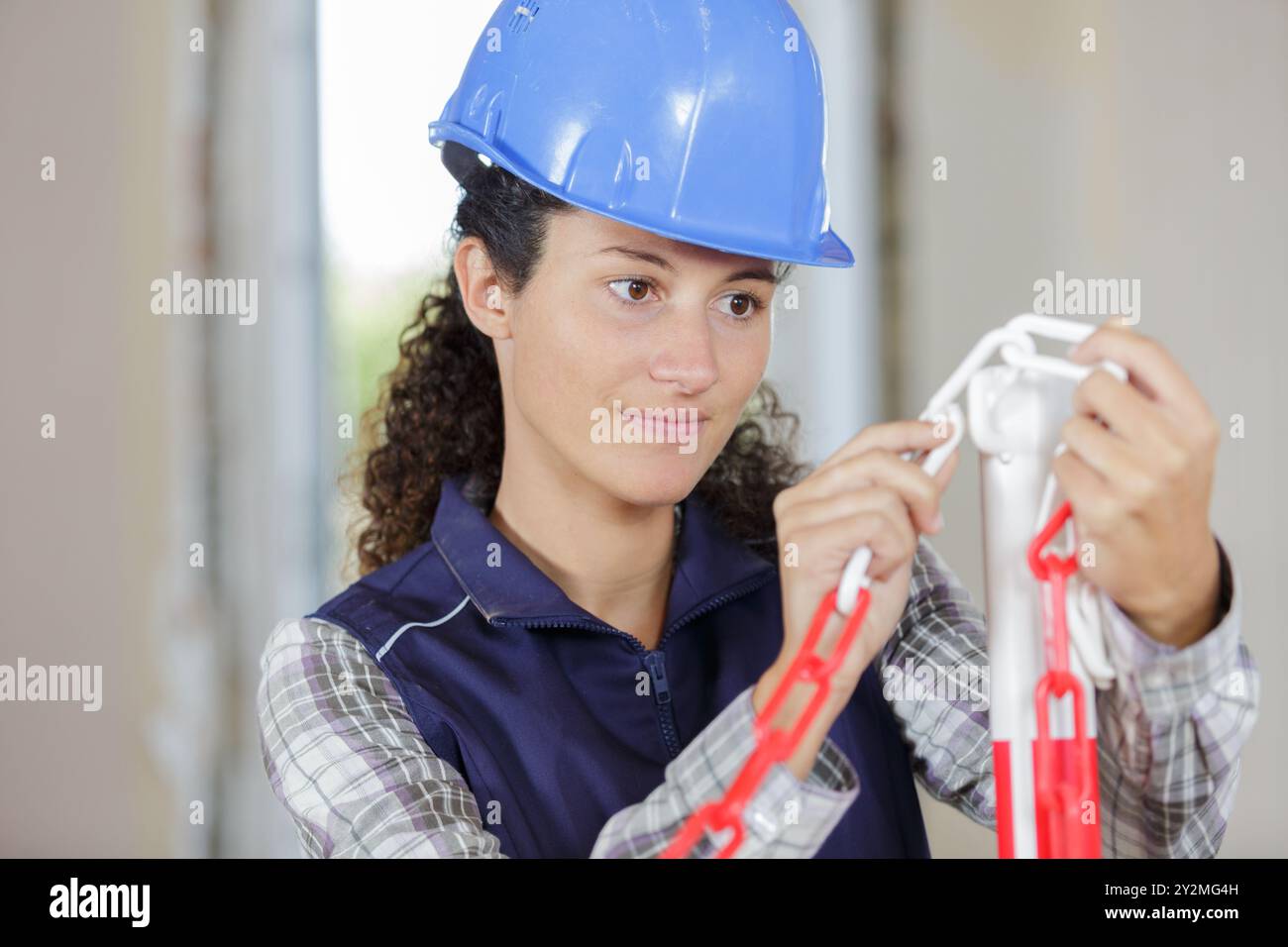 young woman with safety helmet at work Stock Photo - Alamy