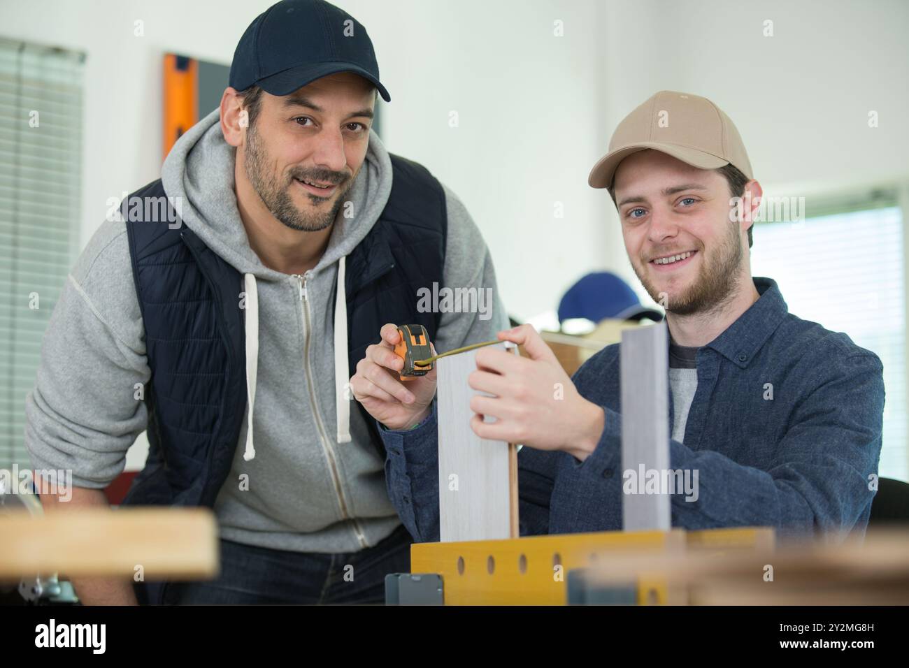 two men at work cutting plywood panels Stock Photo - Alamy