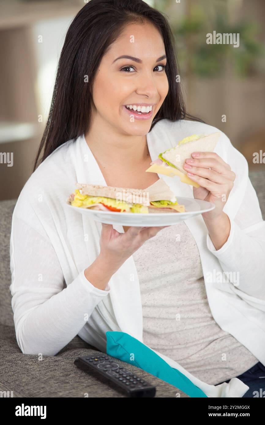 young woman eating wholesome sandwich Stock Photo - Alamy