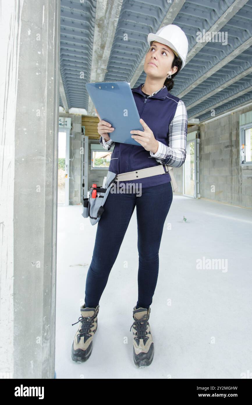 female builder with a clipboard Stock Photo - Alamy