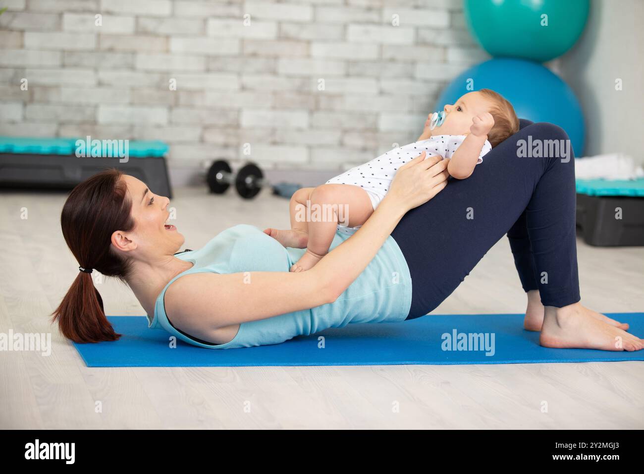 mother with the baby boy doing yoga exercises Stock Photo - Alamy