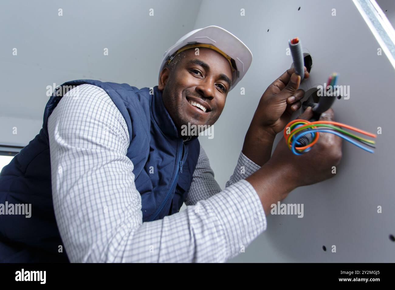 happy electrician installing socket in new house Stock Photo - Alamy