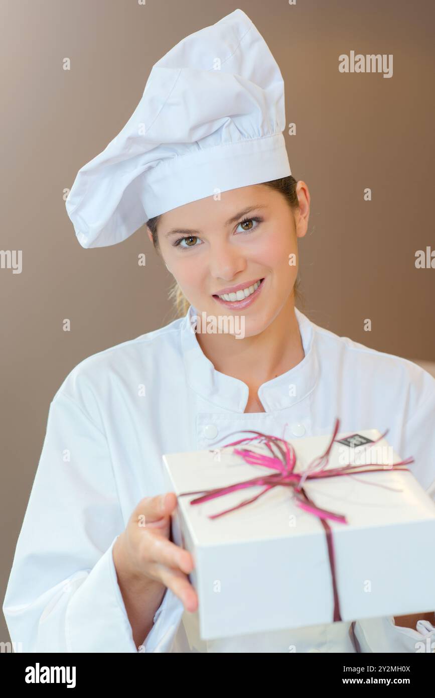 a chef with a gift in the box Stock Photo - Alamy